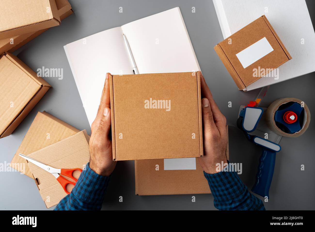 Above table top view of warehouse preparing post courier delivery ...