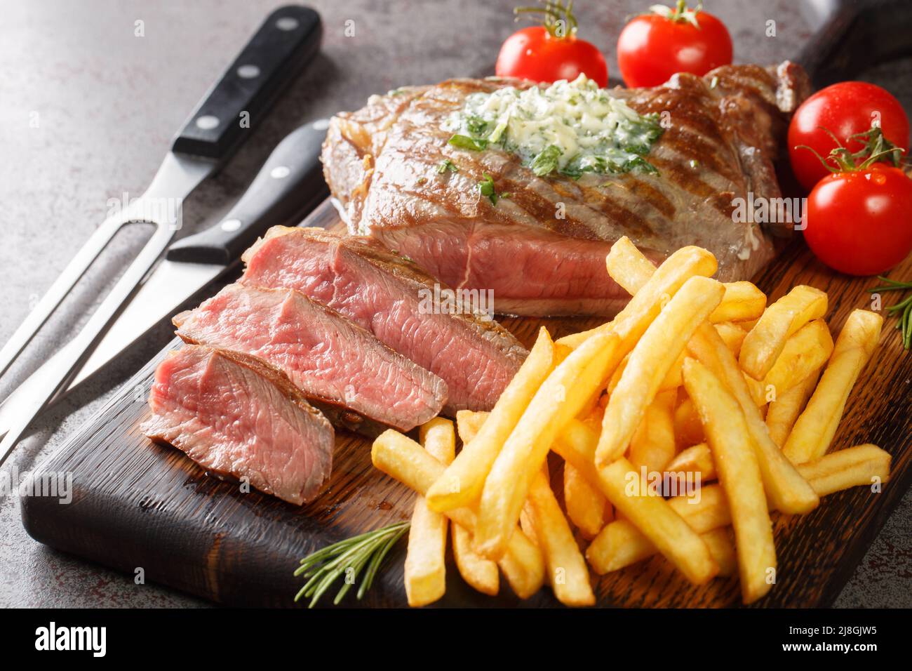 Steak Frites with lemon herb butter is a classic French dish closeup on ...