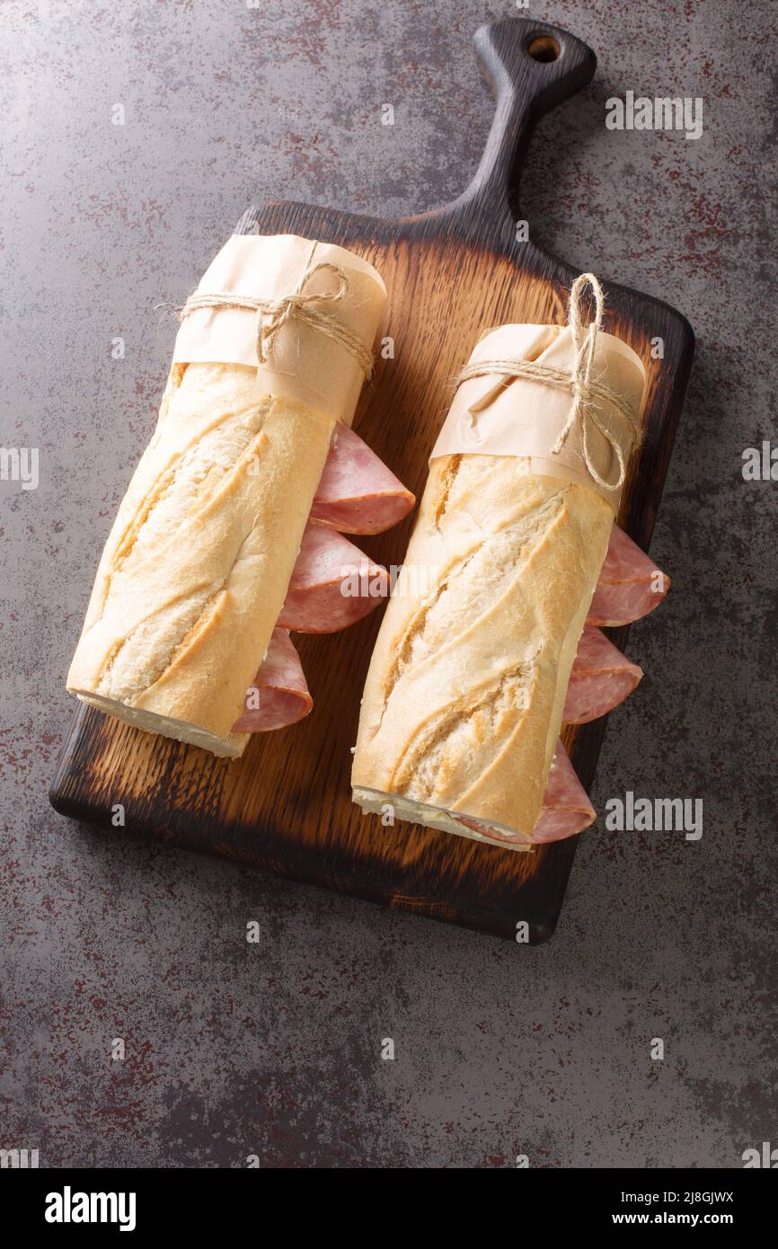 Classic Parisian Jambon-Beurre Sandwich closeup on the wooden board ...