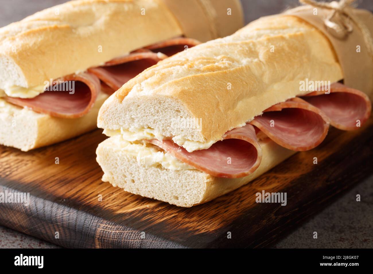 Classic Parisian Jambon-Beurre Sandwich closeup on the wooden board ...