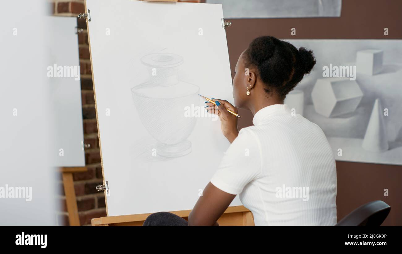African american woman drawing professional sketch on canvas, using ...