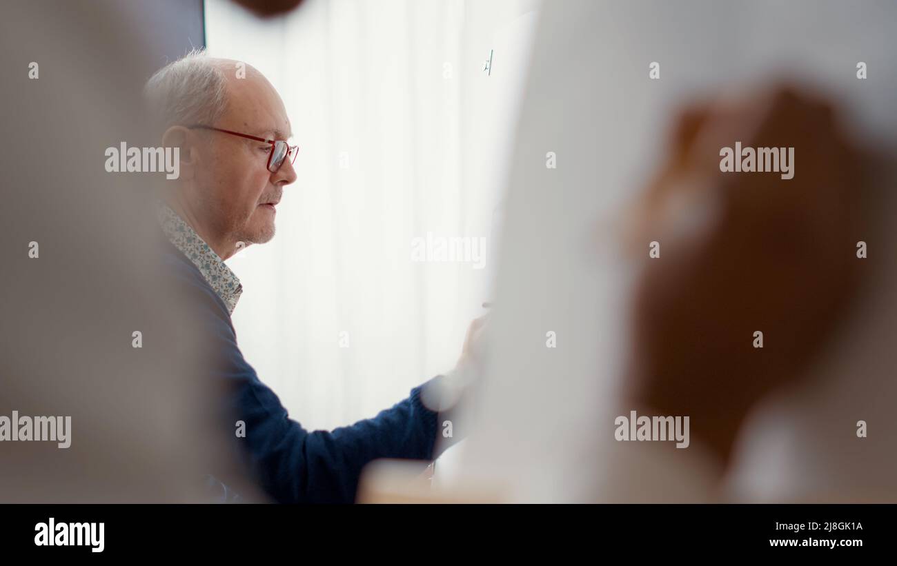 Elder person attending art class hi-res stock photography and images ...