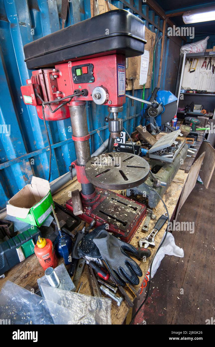 pillar drill on untidy workshop bench Stock Photo - Alamy