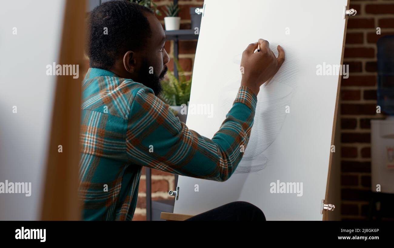Young student creating vase drawing with pencil on canvas, developing ...