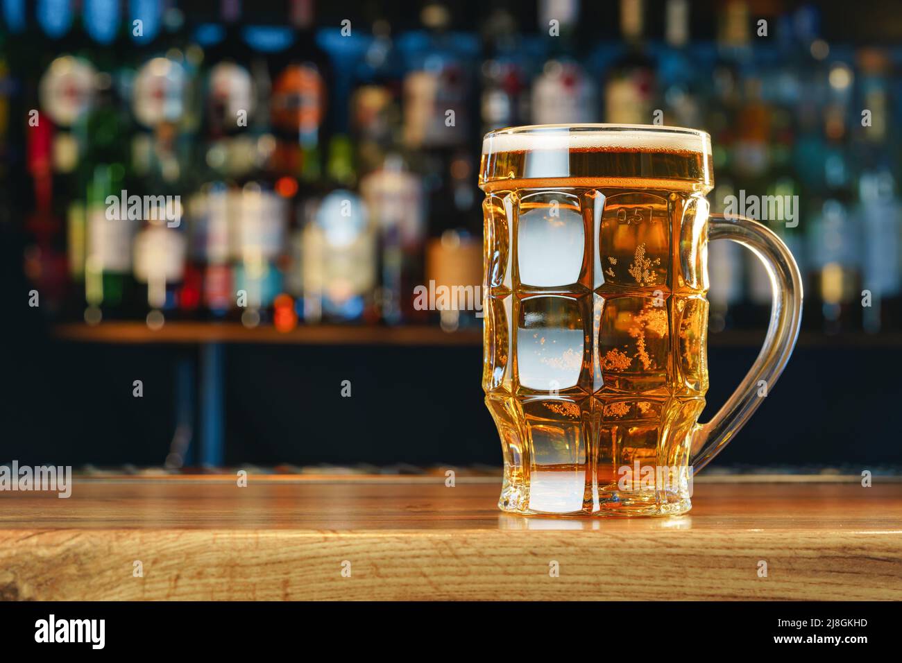 Fresh cold beer in glass on bar background Stock Photo - Alamy