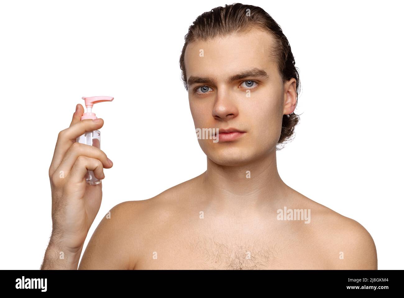 Portrait of young attractive man with perfect smooth skin, applying ...