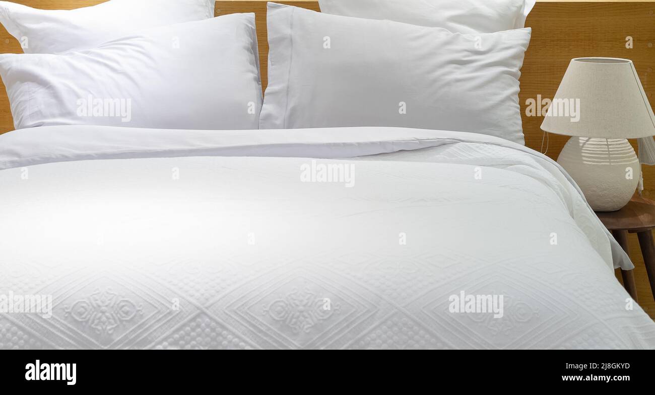 Snow-white cotton bed linen is presented in store. Cozy bedding ...
