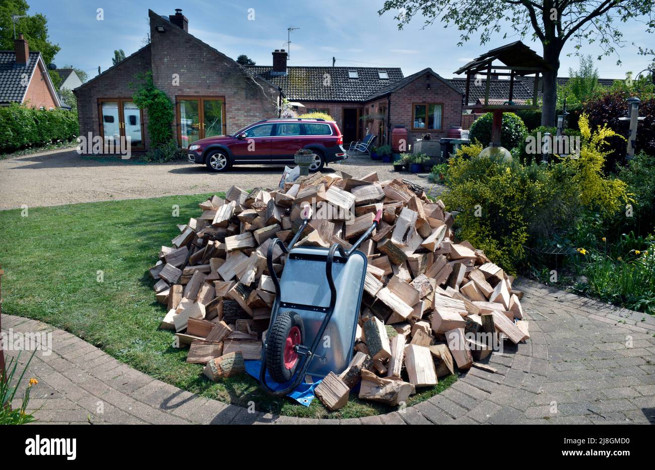 freshly delivered pile of logs outside rural bungalow norfolk england ...