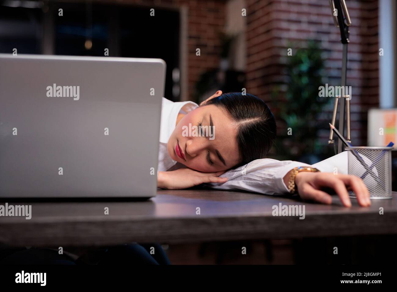 Exhausted agency worker falling asleep in office workspace while ...