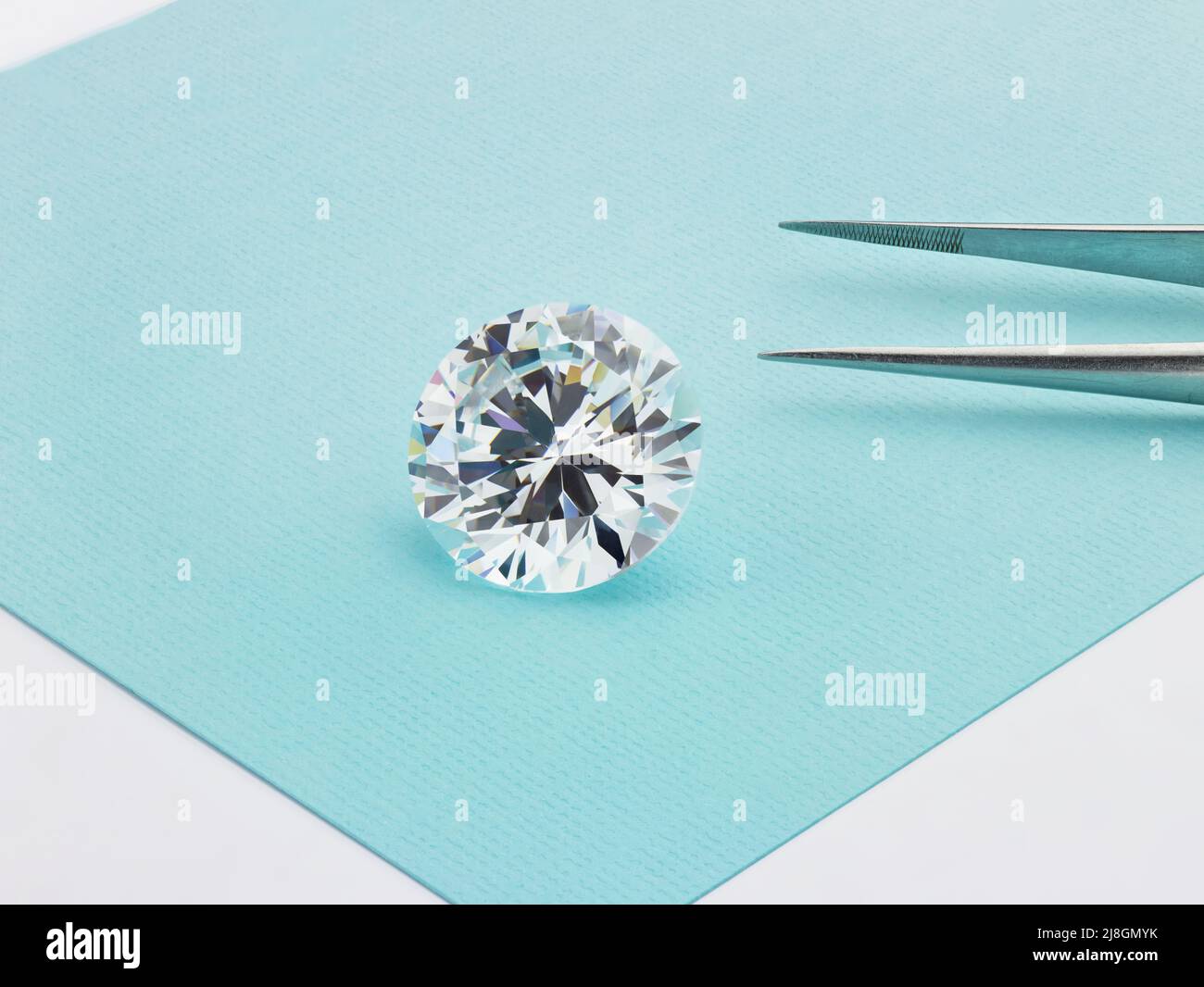 Big Diamond with Tweezers on Tiffany Blue Background Stock Photo - Alamy
