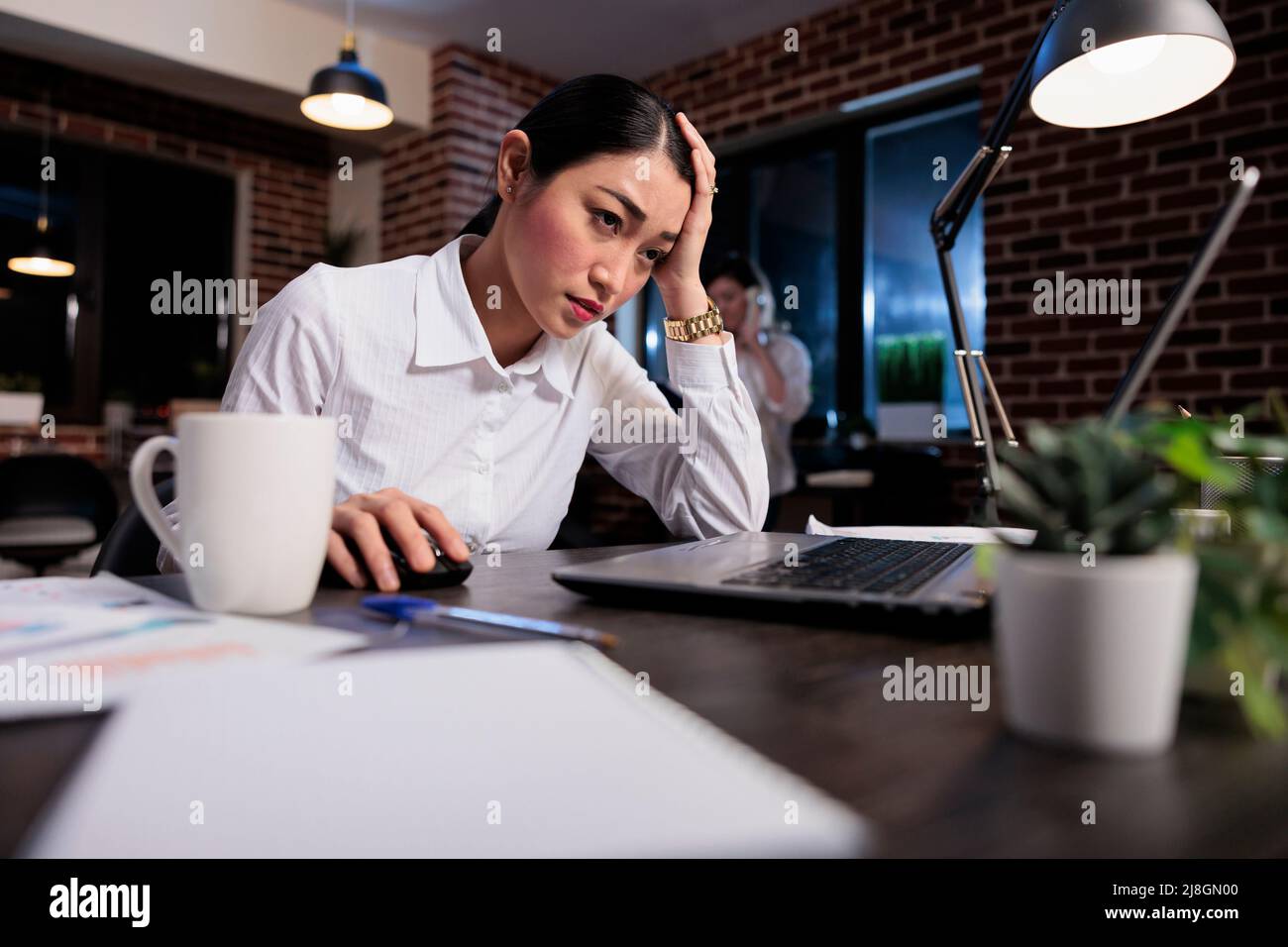 Tired accountant suffering from migraine sitting in office workspace ...