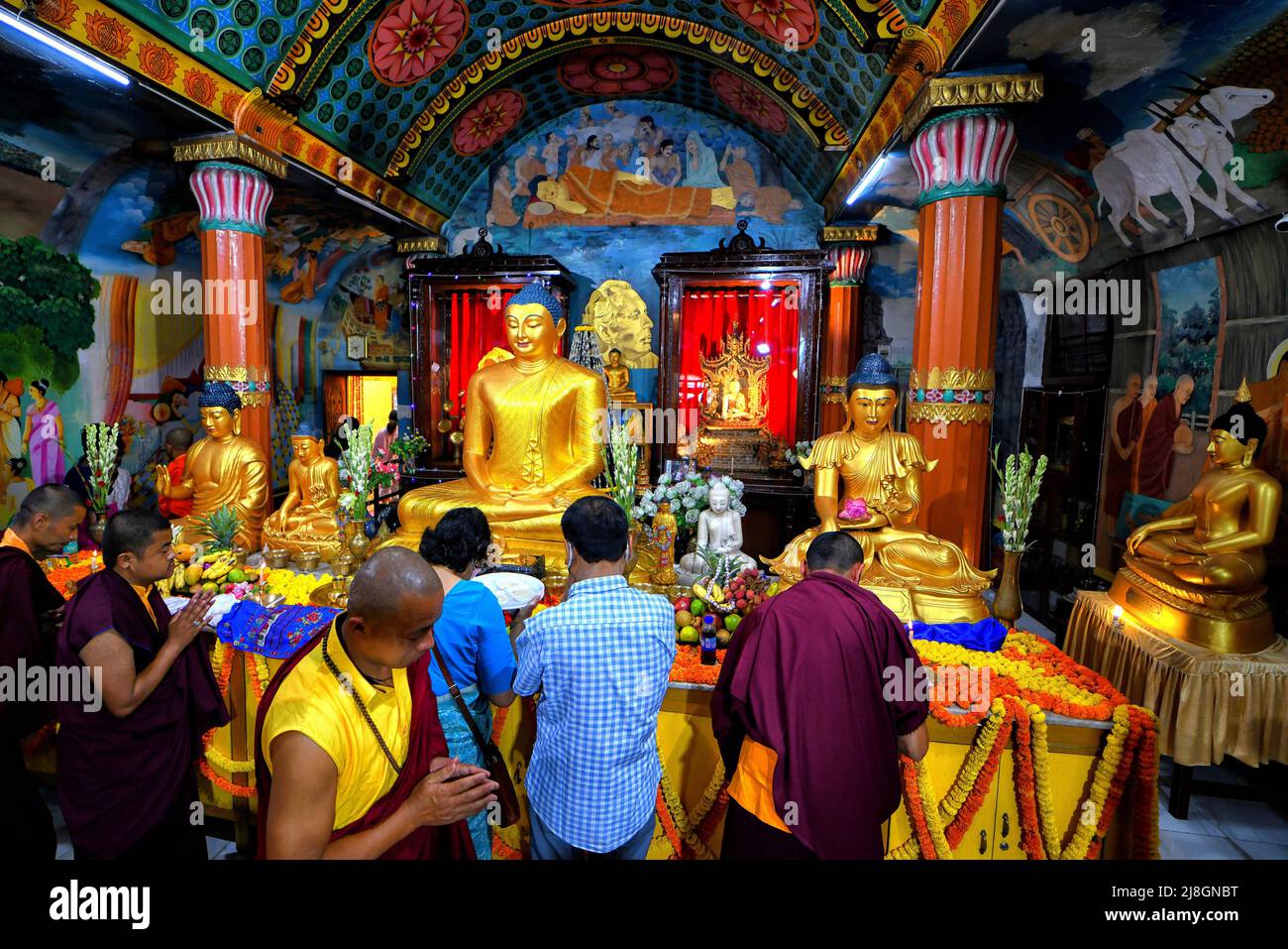 Buddhist devotees are seen praying in front of a statue of Lord Buddha ...