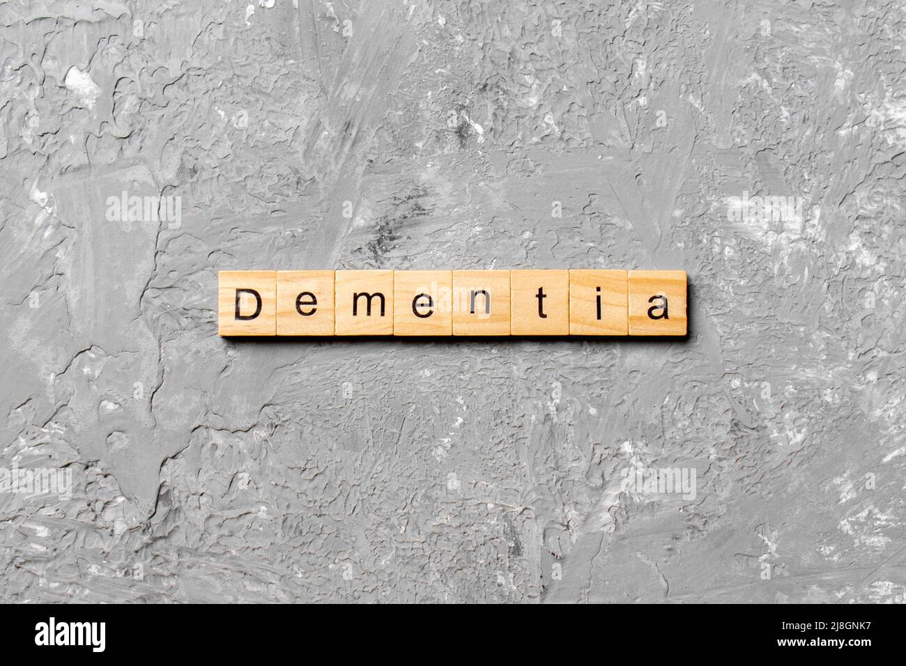 Dementia word written on wood block. Dementia text on cement table for ...