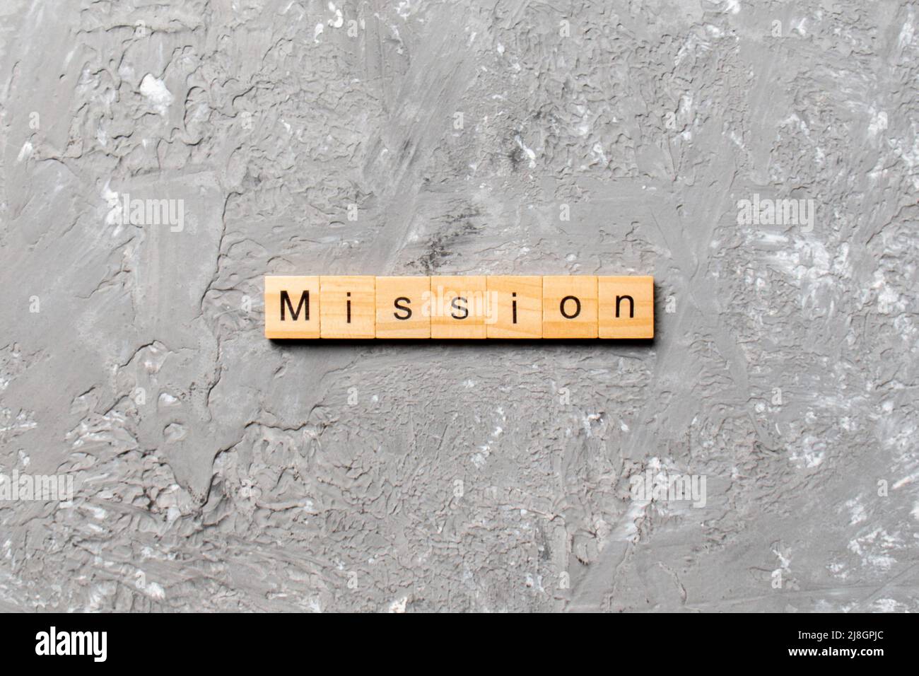 MISSION word written on wood block. MISSION text on table, concept ...
