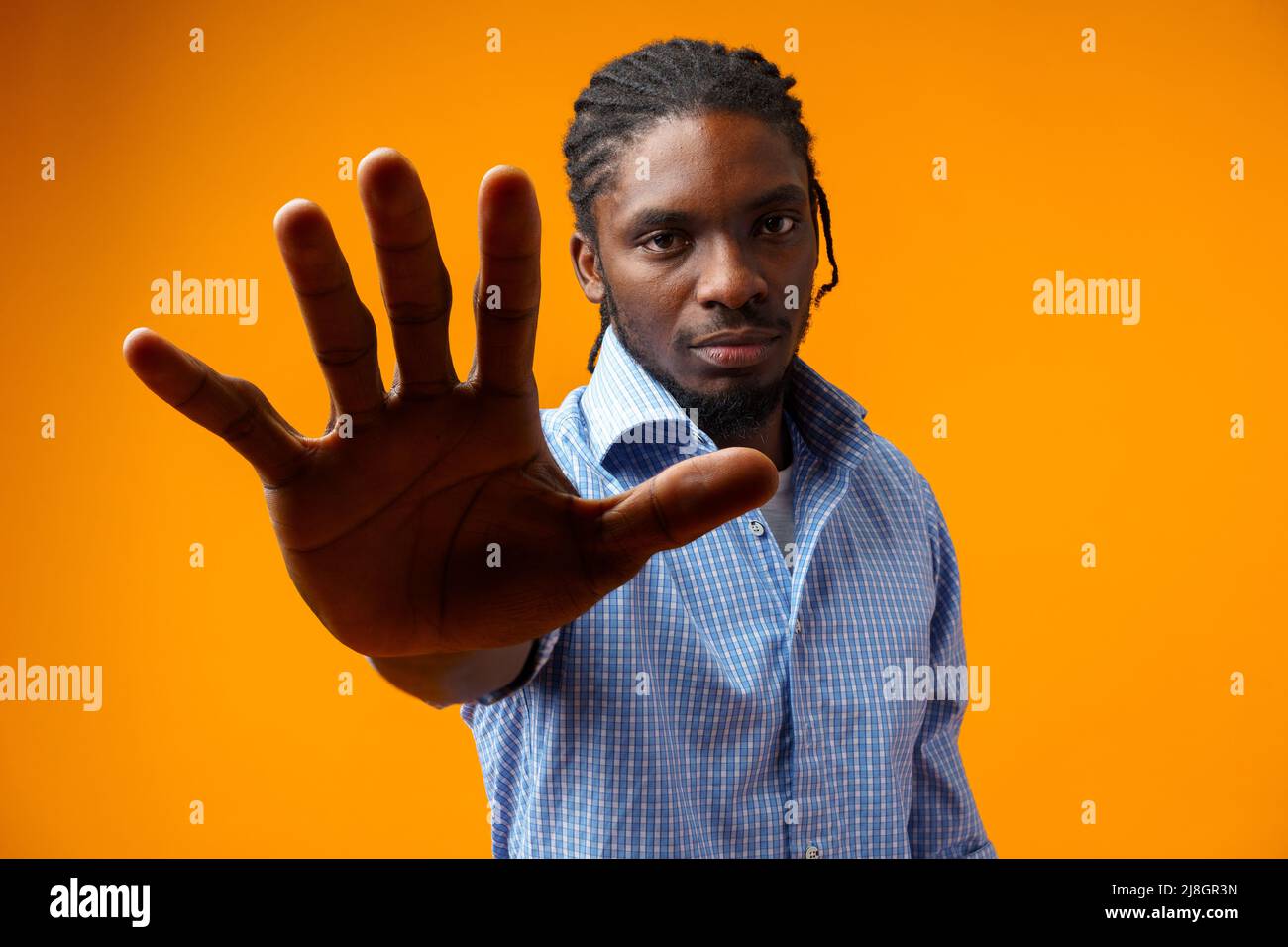 Portrait of serious African American male showing hand stop sign Stock ...
