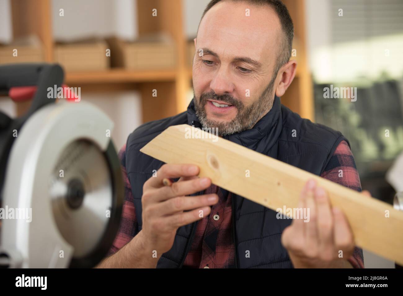 Man holding saw hammer wood hi-res stock photography and images - Alamy