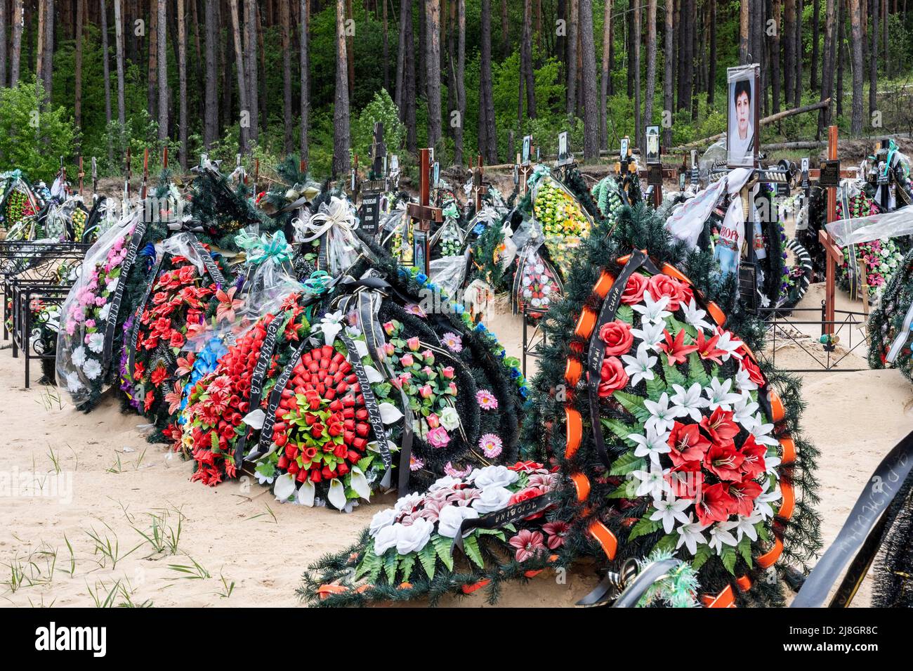 Irpin, Kyiv Oblast, Ukraine. 15th May, 2022. A graveyard with people ...