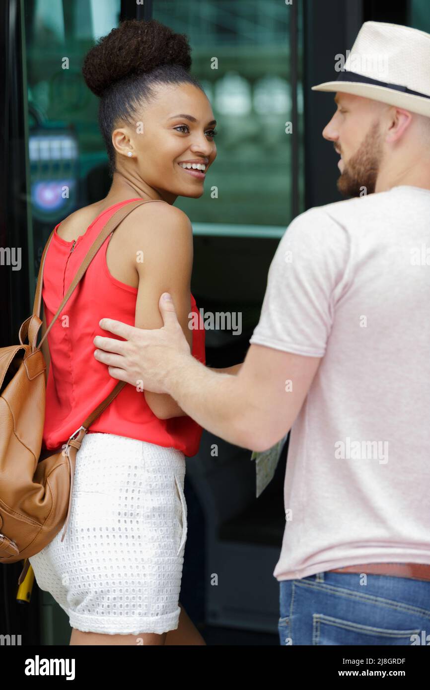 gentleman helping woman on to public-transport Stock Photo - Alamy