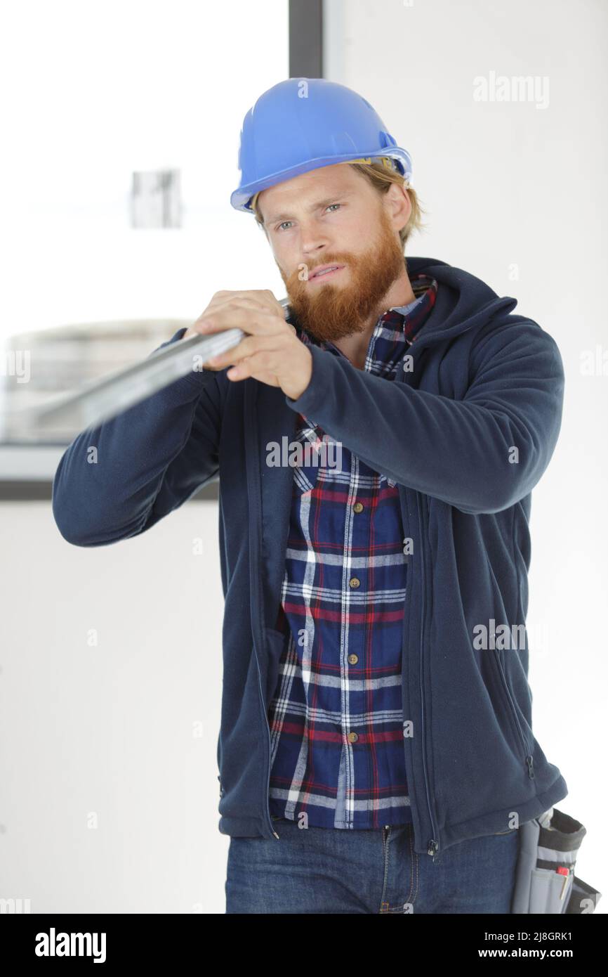 Man carrying metal beam hi-res stock photography and images - Alamy