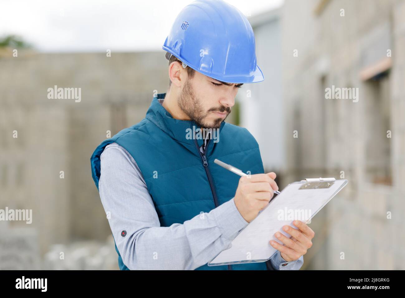 builder in hard hat and clipboard Stock Photo - Alamy