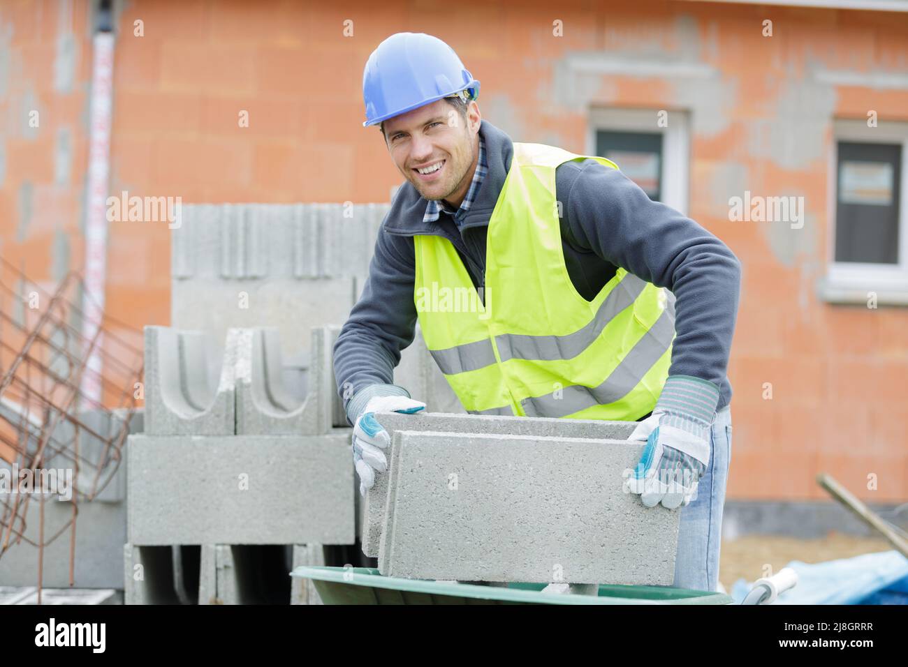 handsome man working on concrete mix bricks Stock Photo - Alamy