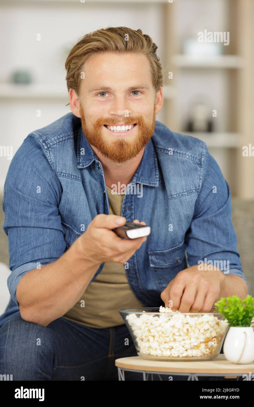 happy man with tv remote control enjoying time alone Stock Photo - Alamy