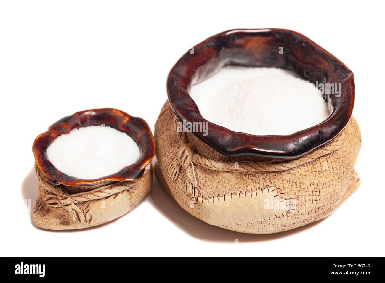 Bowls of white table salt isolated on white background Stock Photo - Alamy