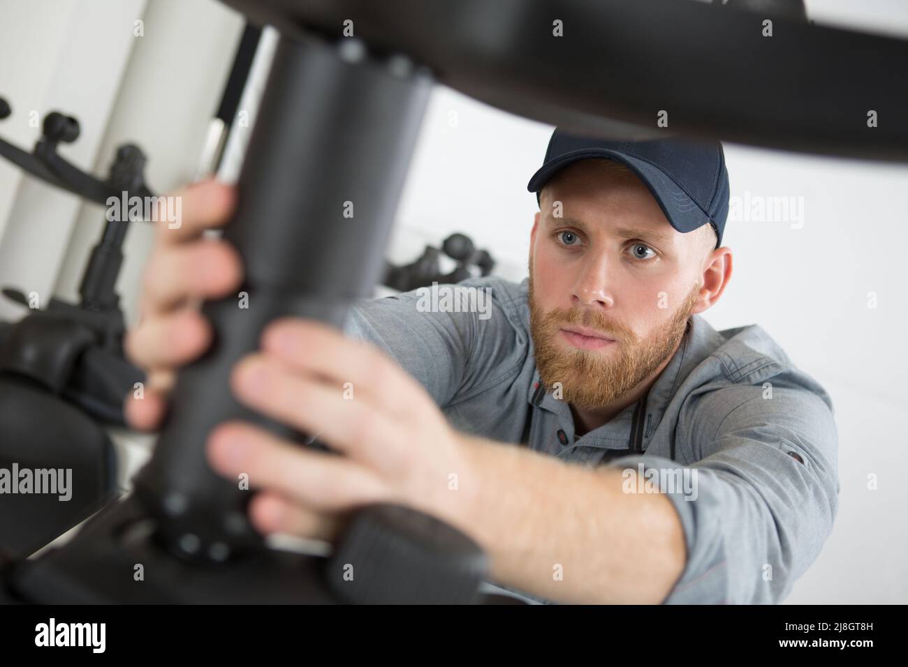 workman assembling an office chair Stock Photo - Alamy