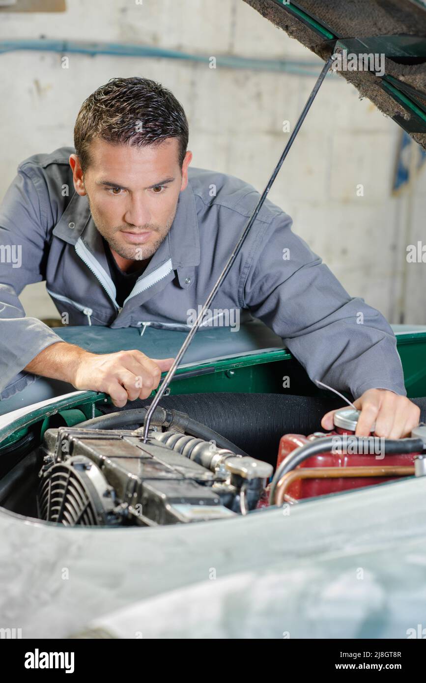 Male mechanic leaning engine hi-res stock photography and images - Alamy