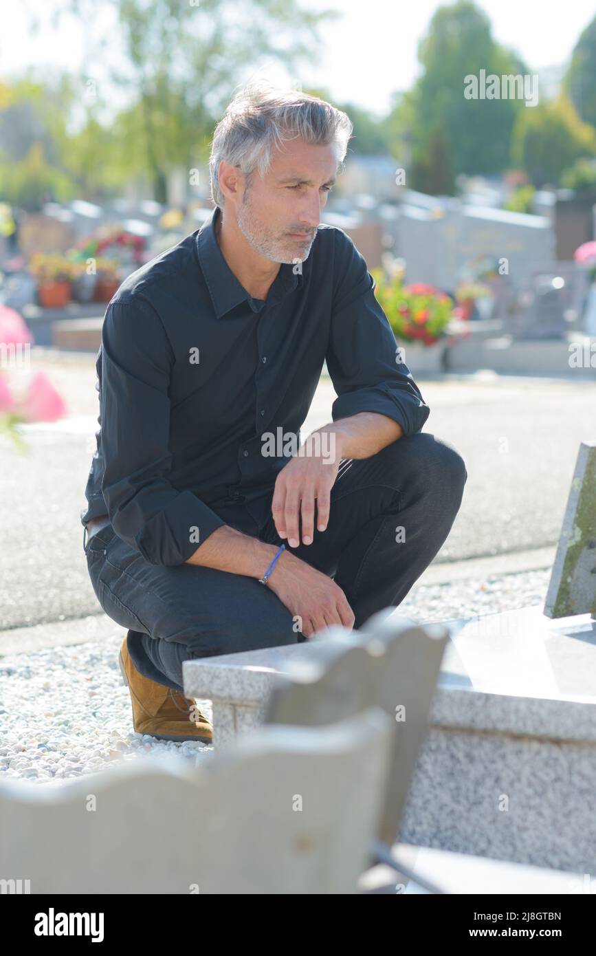 portrait of a man mourning at grave Stock Photo - Alamy