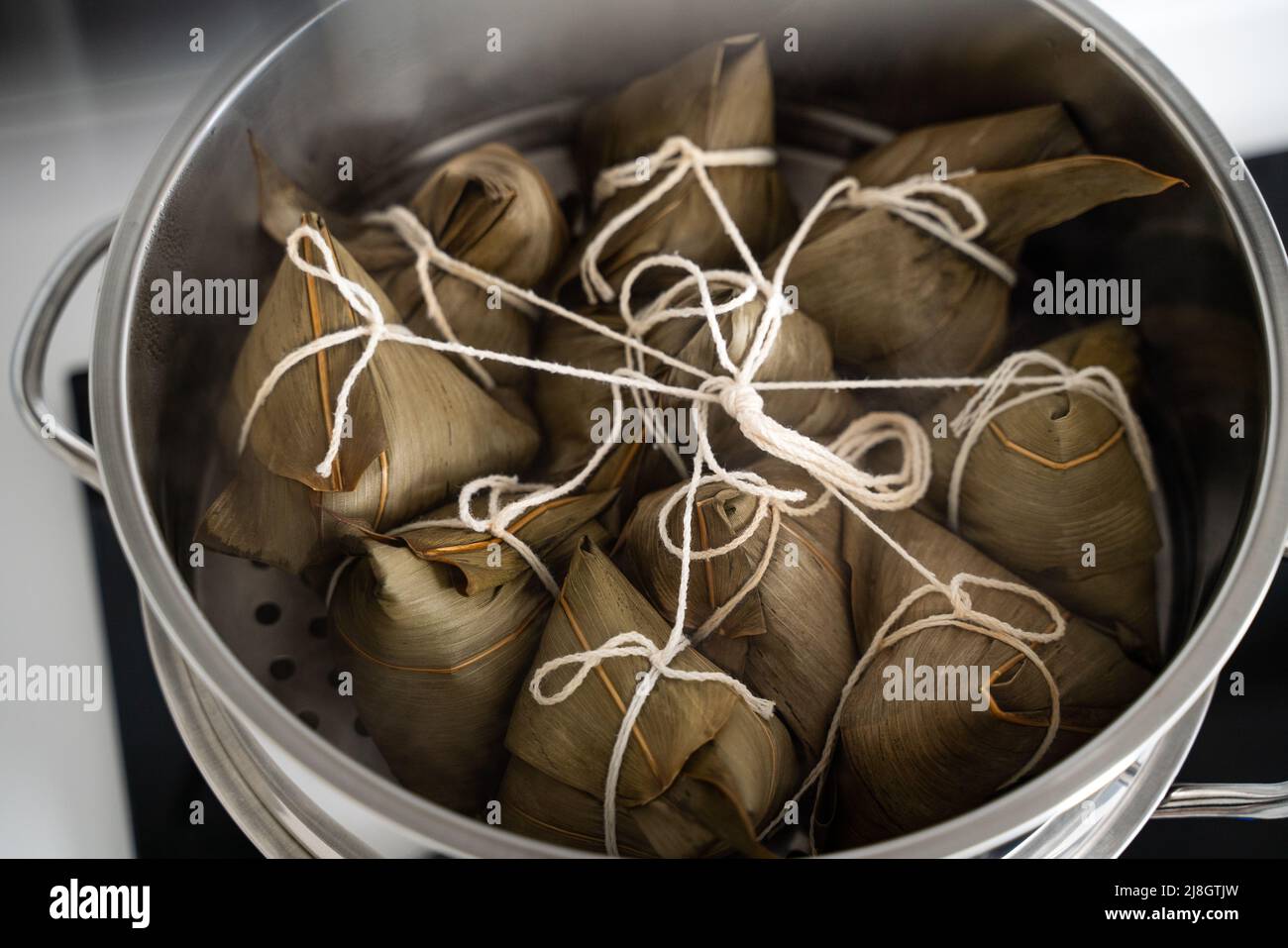 Cooking zongzi food - preparing and steaming Chinese rice dumpling at ...