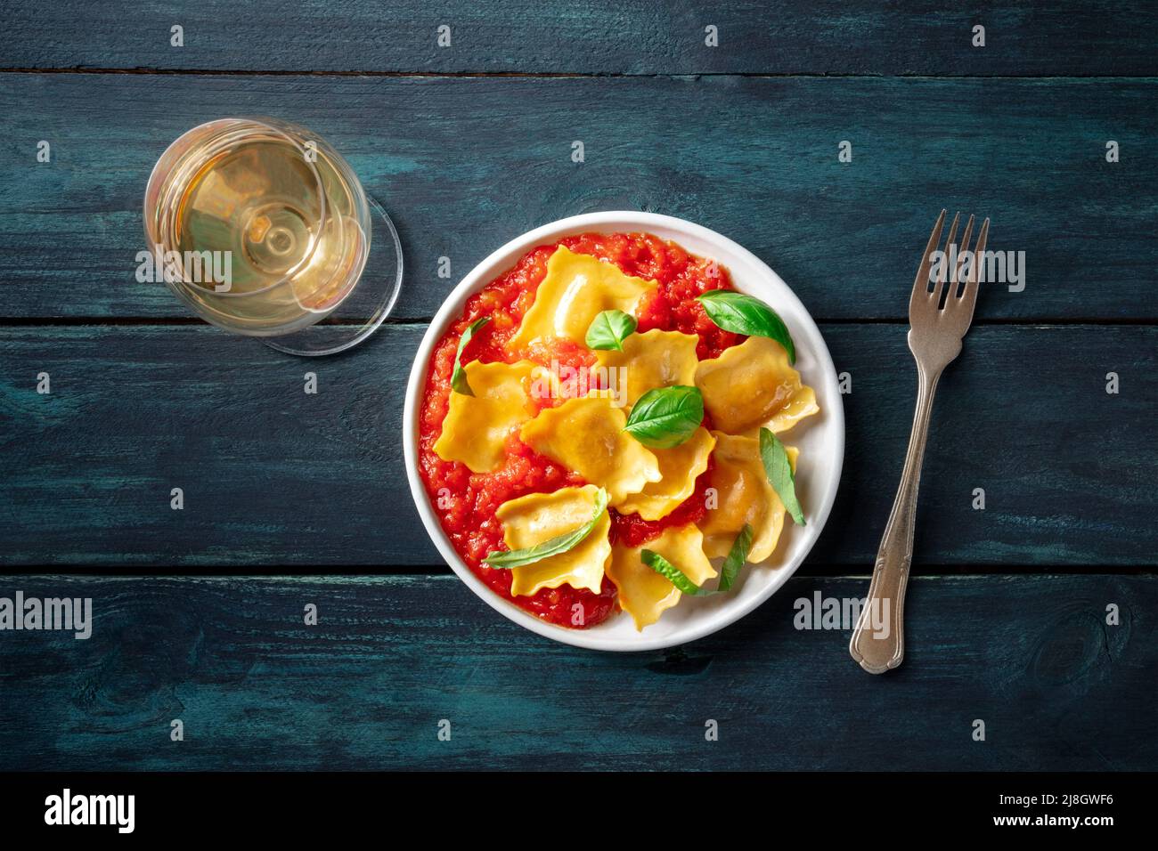 Ravioli with tomato sauce and fresh basil leaves on a plate, Italian ...