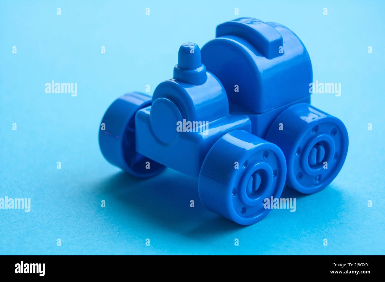 Plastic train blocks on blue background. Copy space Stock Photo - Alamy