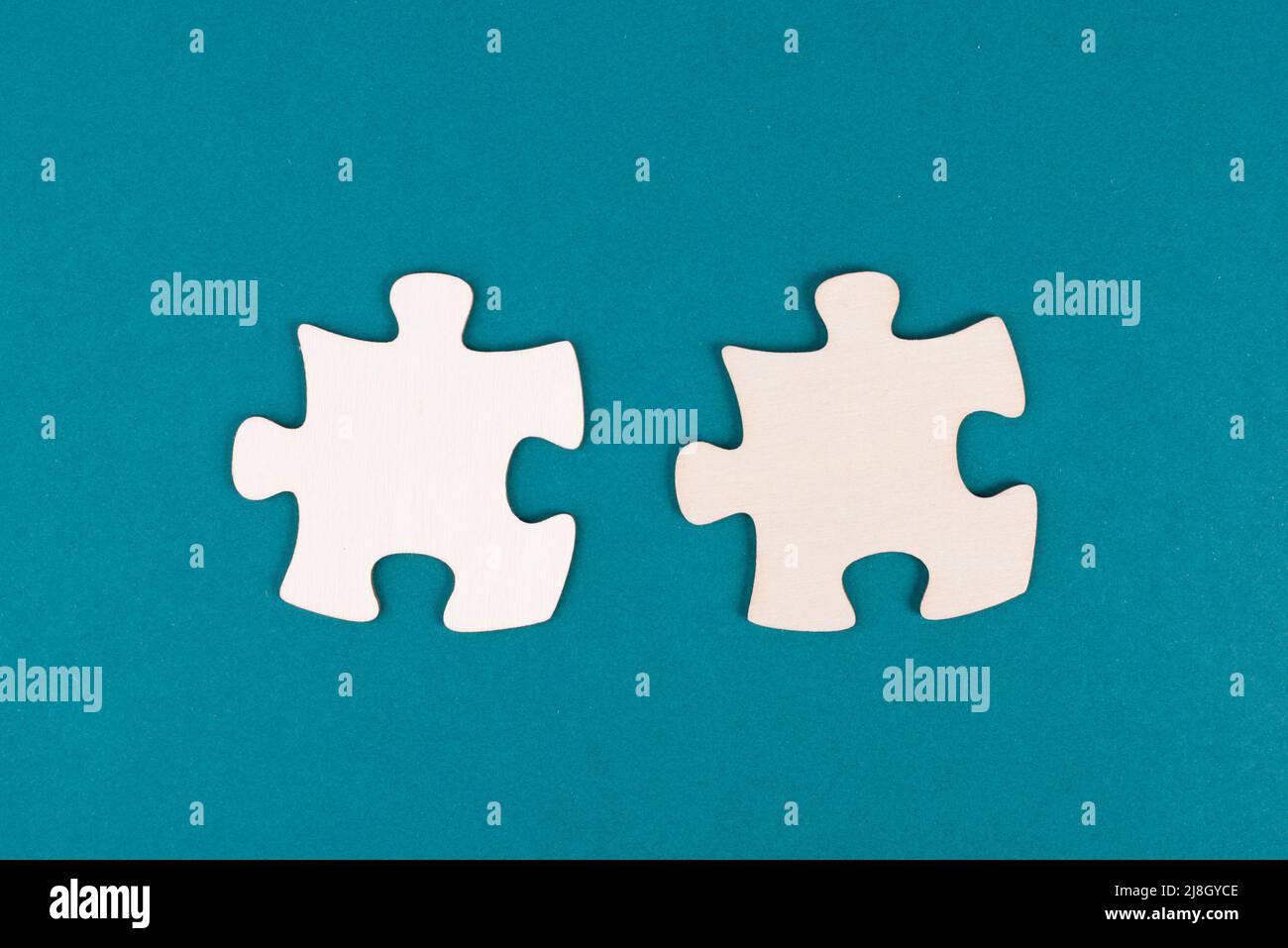 Two pieces of a puzzle, connecting together as a team, solving a ...