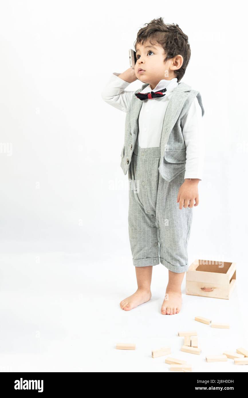 child talking on cell phone on white background Stock Photo - Alamy