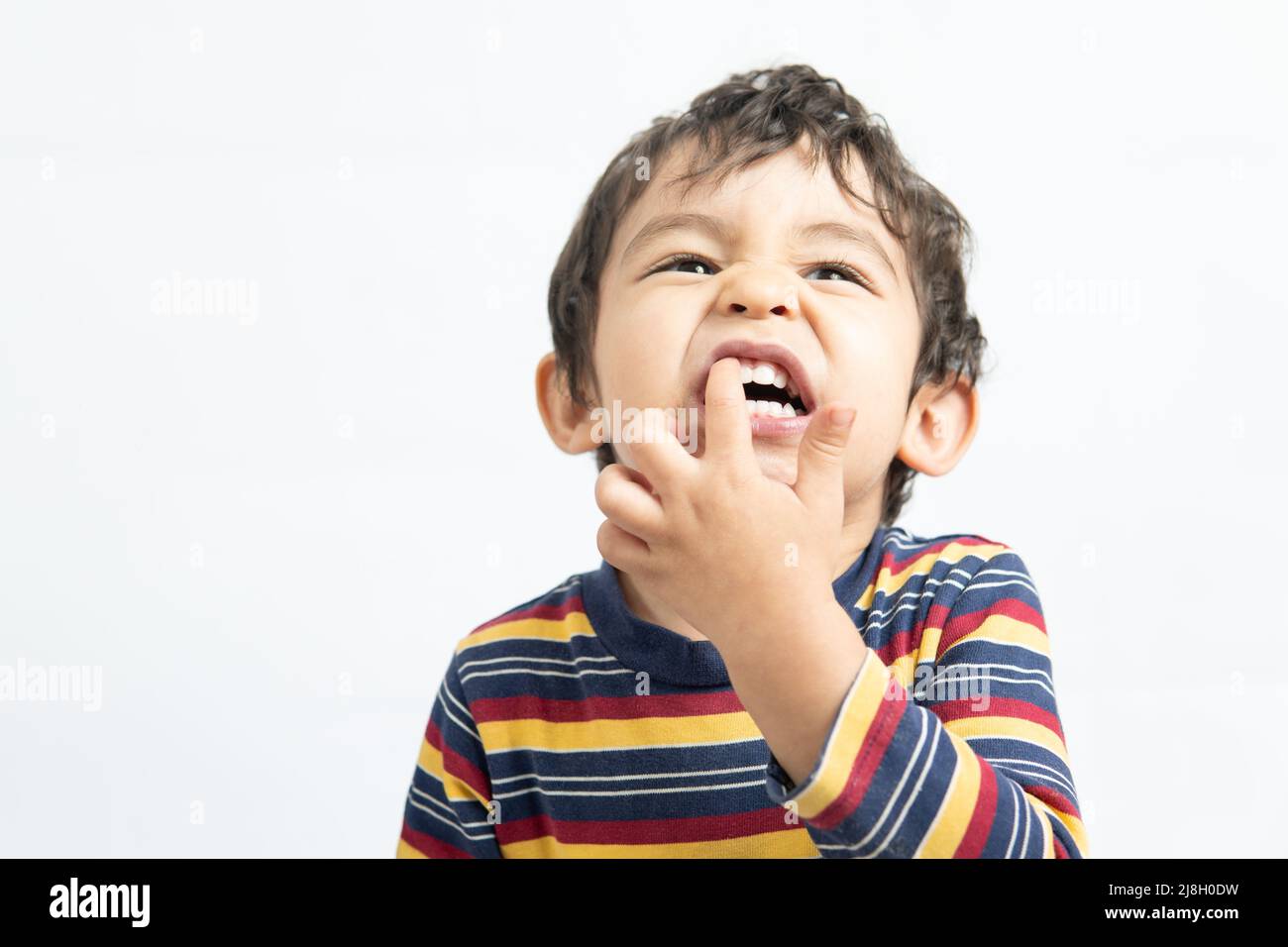 child showing teeth with hand on white background Stock Photo - Alamy