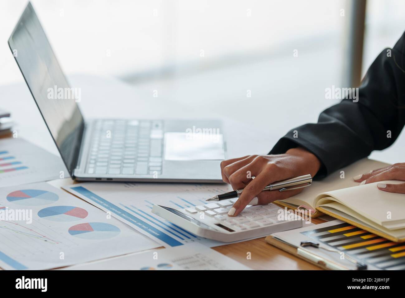 Close up Business woman hand using calculator to calculate the company ...