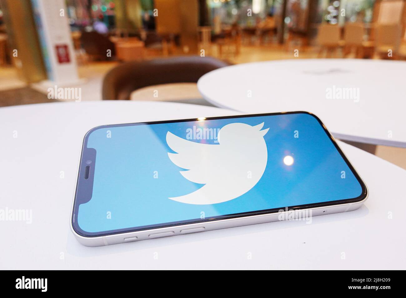 In this photo illustration, a Twitter logo is displayed on the screen ...