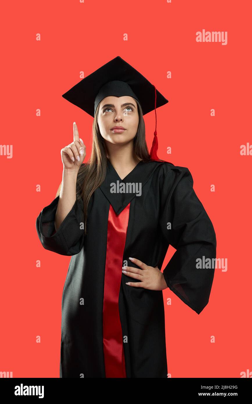 Front view of young female graduating from college, university. Pretty ...