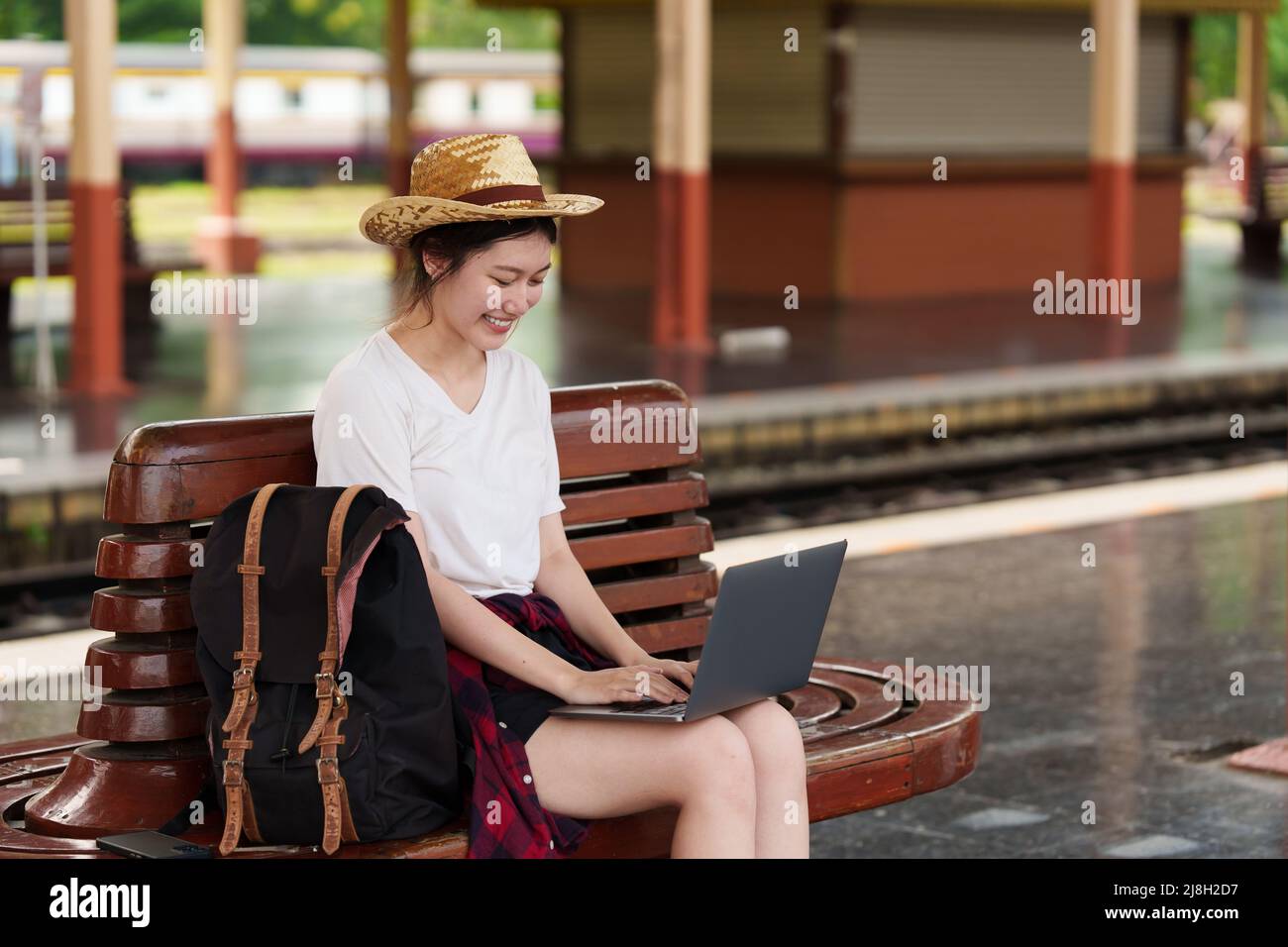 Image of Young freelance working at train station before travel. work ...