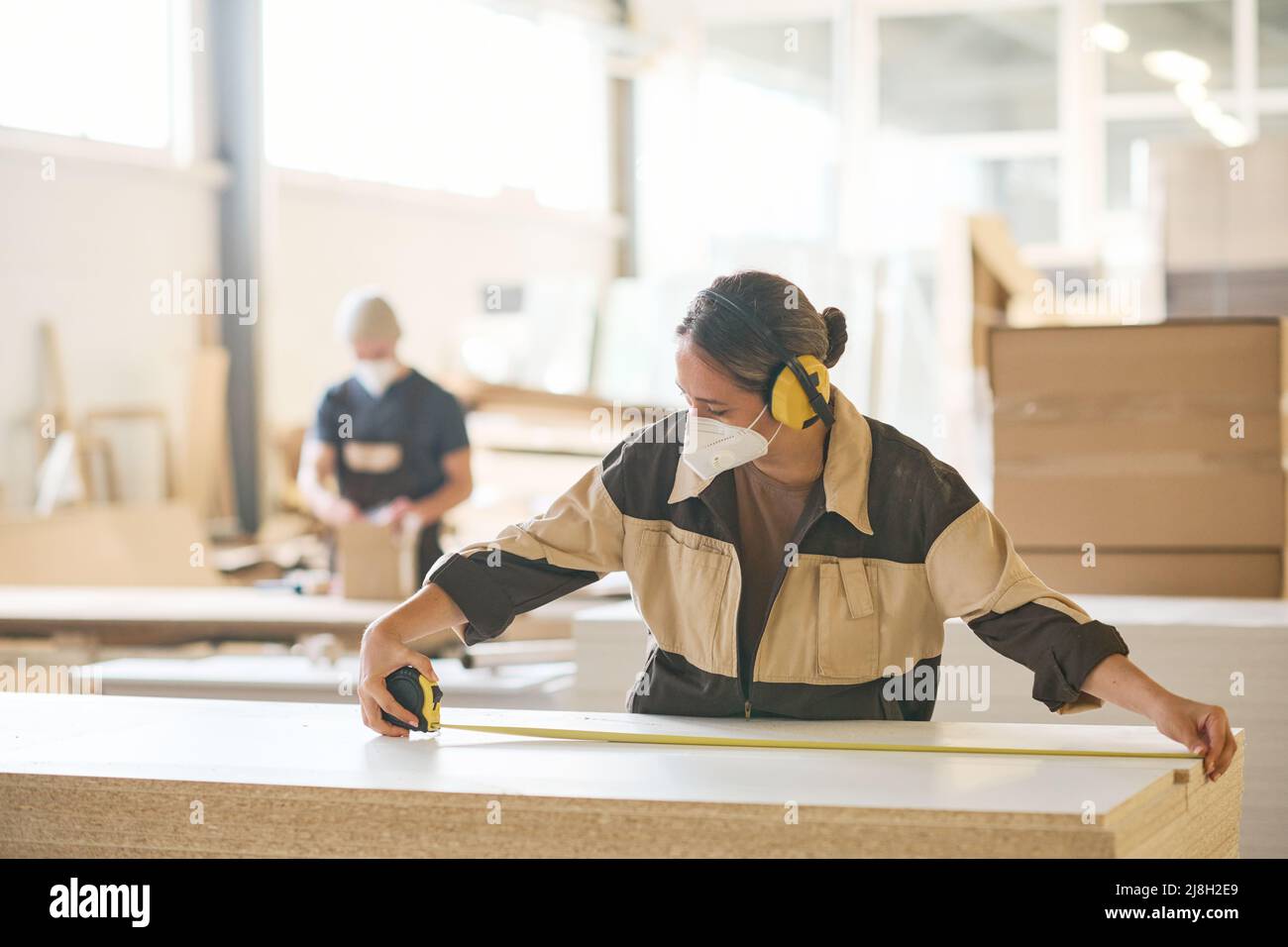 Woman using tape measure check hi-res stock photography and images - Alamy