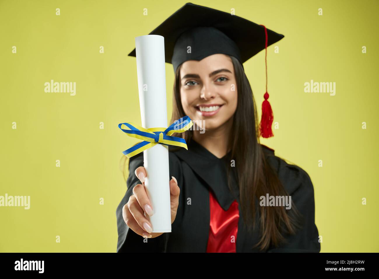 Front view of brunette girl showing Ukrainian diploma. Pretty female ...