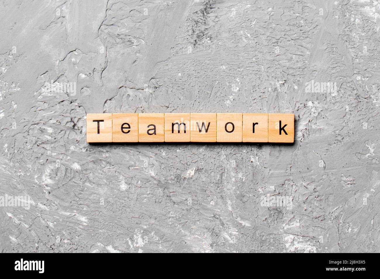 TEAMWORK word written on wood block. TEAMWORK text on cement table for your desing, concept ...