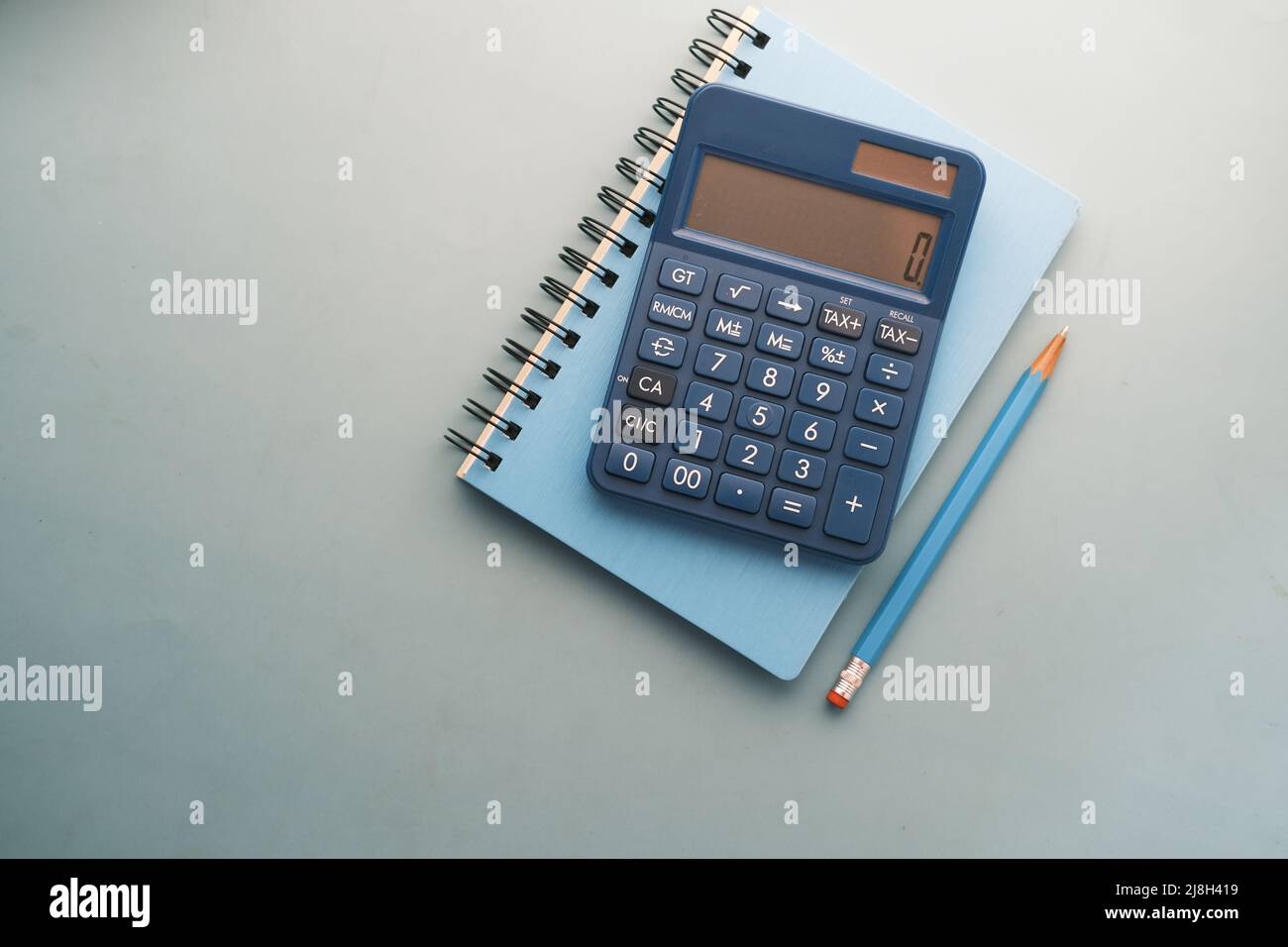 top view of blue calculator and notepad on color background Stock Photo ...