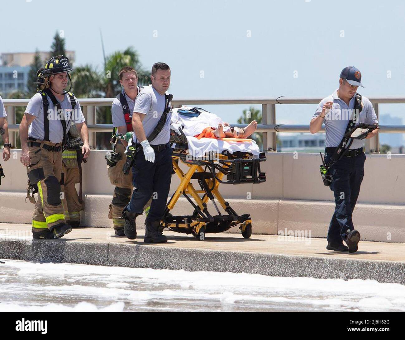 Miami-Dade rescue crews transport an injured patient after a plane hit ...