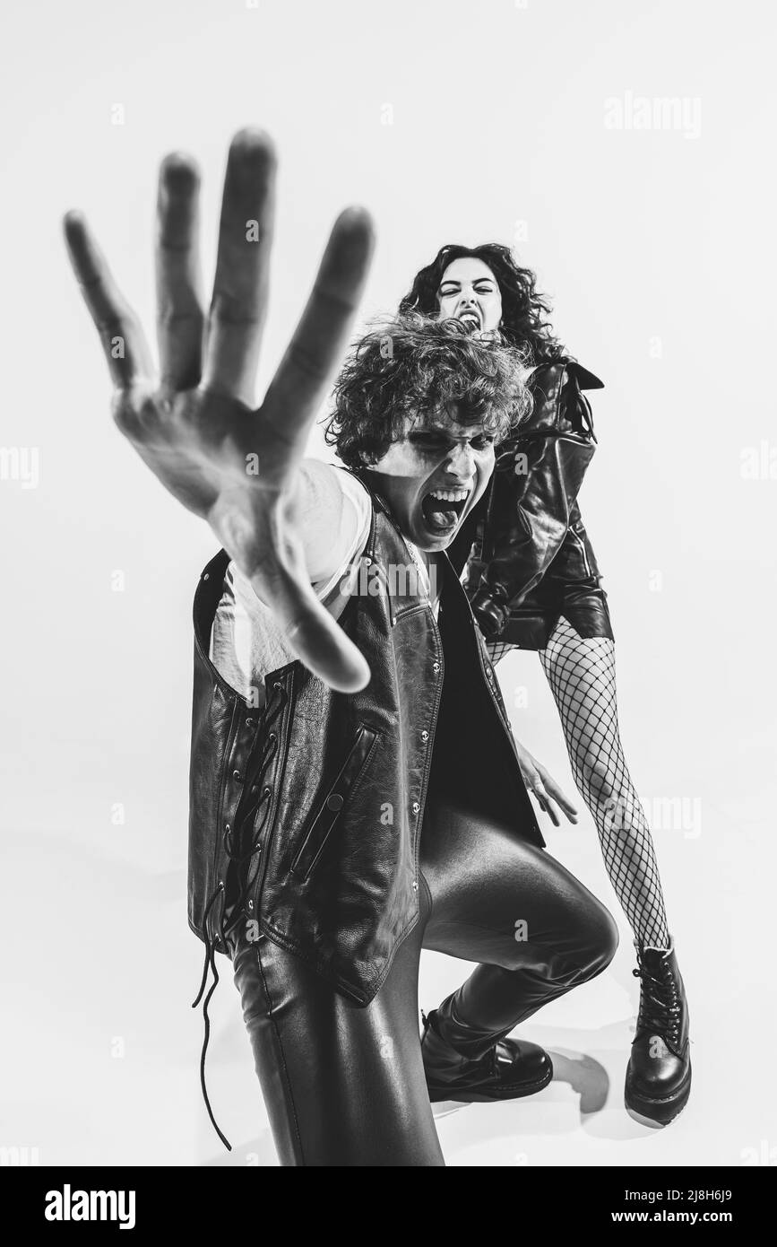 Monochrome portrait of crazy musicians, young couple wearing black ...