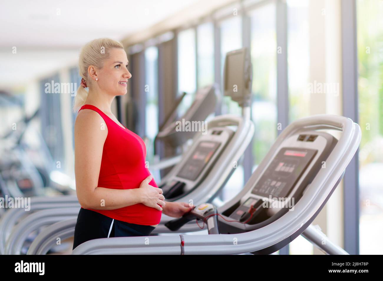Pregnancy fitness. Pregnant woman training in gym. Yoga for mom and ...