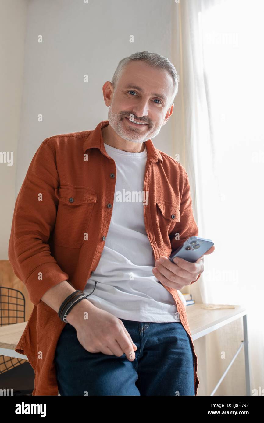 Man in orange shirt hi-res stock photography and images - Alamy