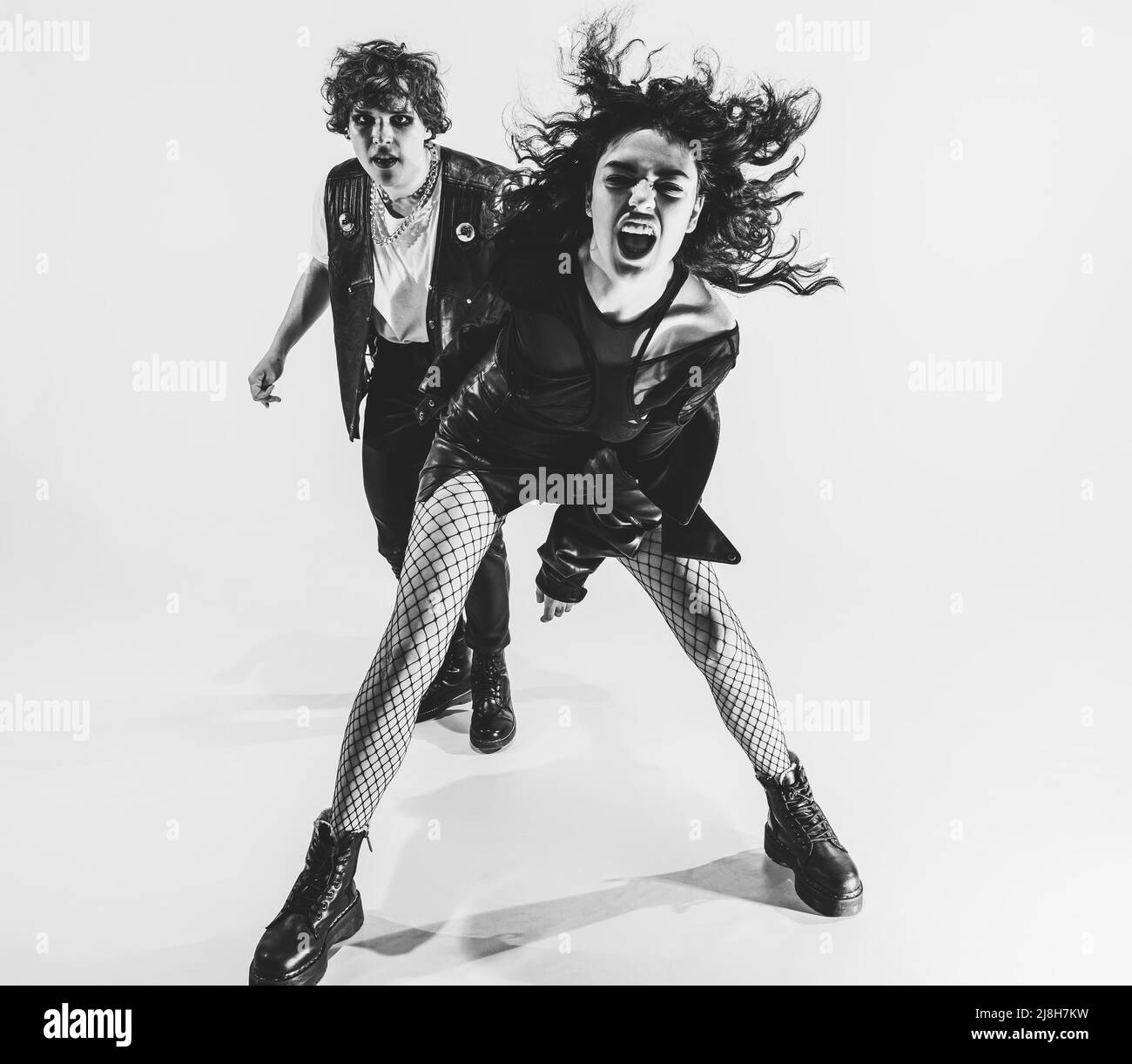 Monochrome portrait of crazy musicians, young couple wearing black ...