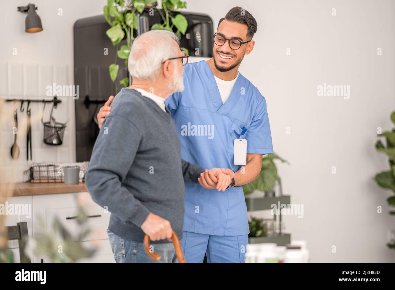 Nurse assisting a patient to walk with a walking stick Stock Photo - Alamy